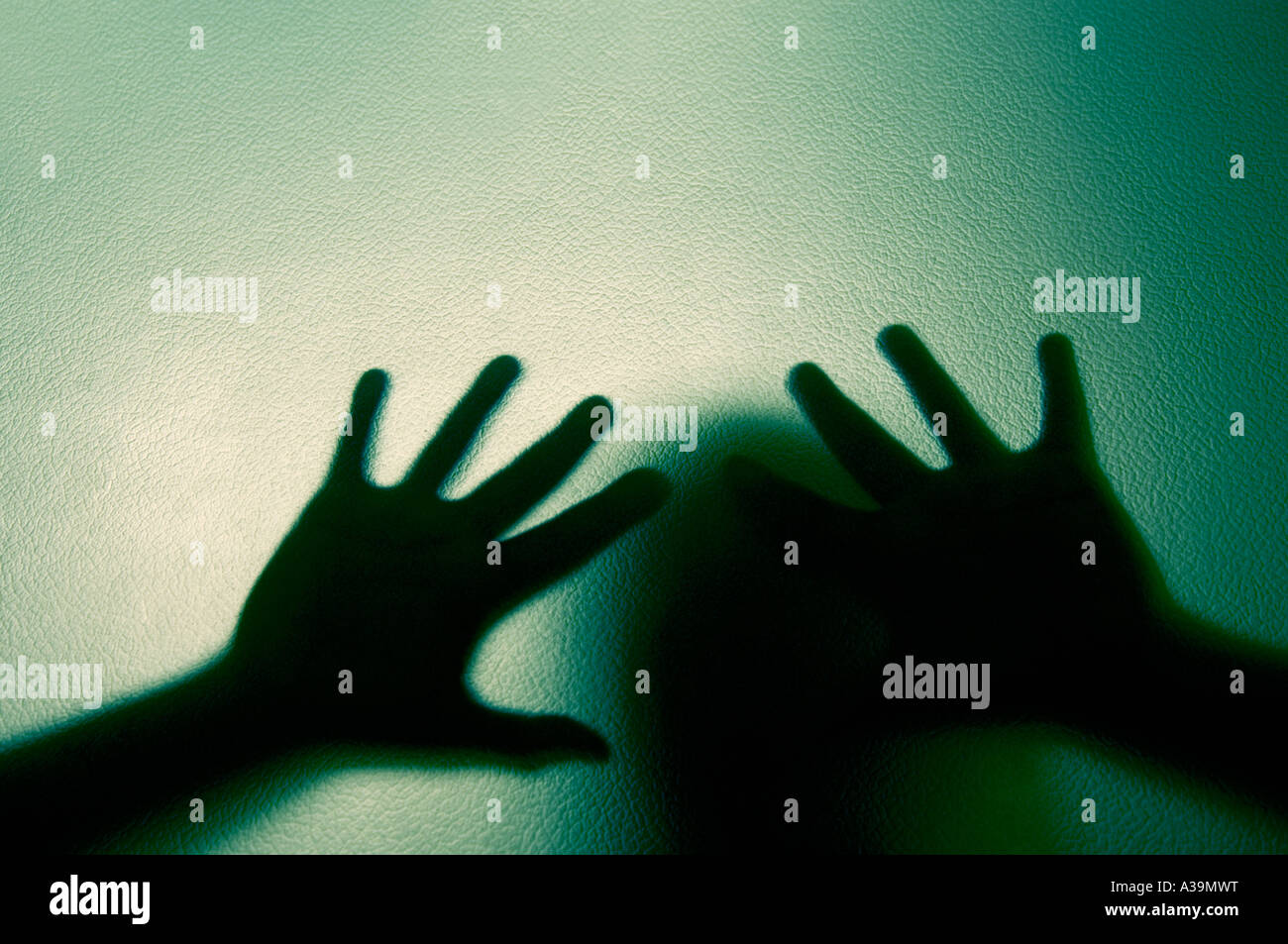 Human figure hiding behind glass Stock Photo - Alamy