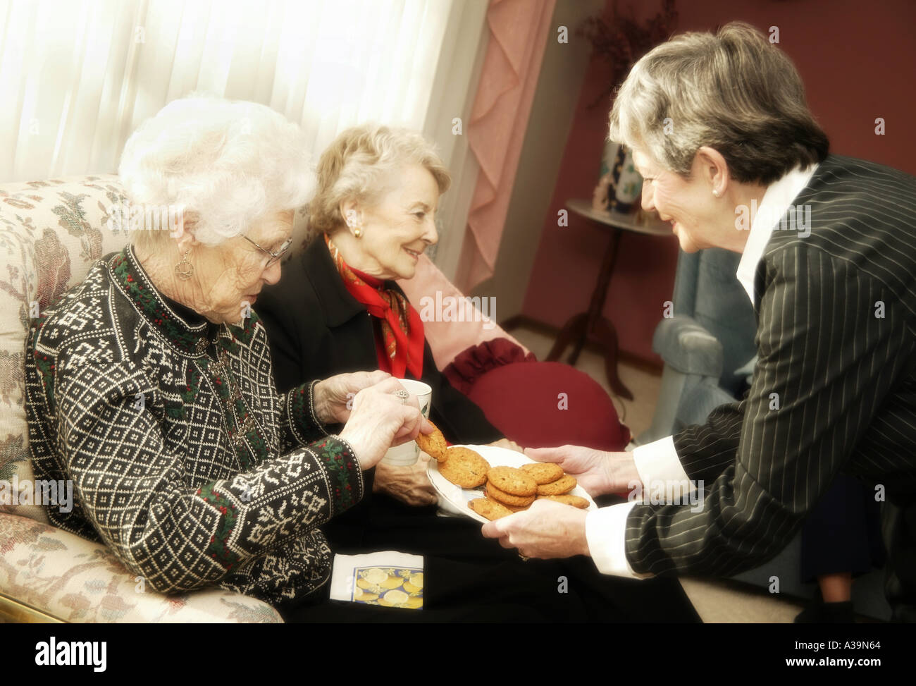 Elderly women having cookies Stock Photo - Alamy