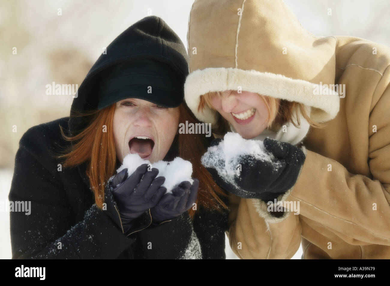 Teen girls eating snow Stock Photo - Alamy