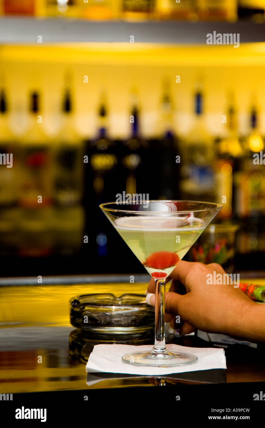 Female's hand next to a martini drink inside a bar Stock Photo - Alamy