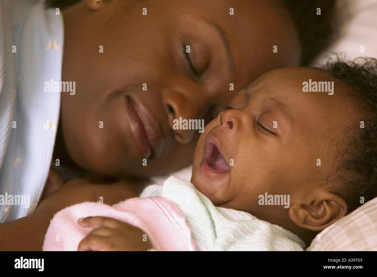 Sleeping mom and yawning baby Stock Photo - Alamy