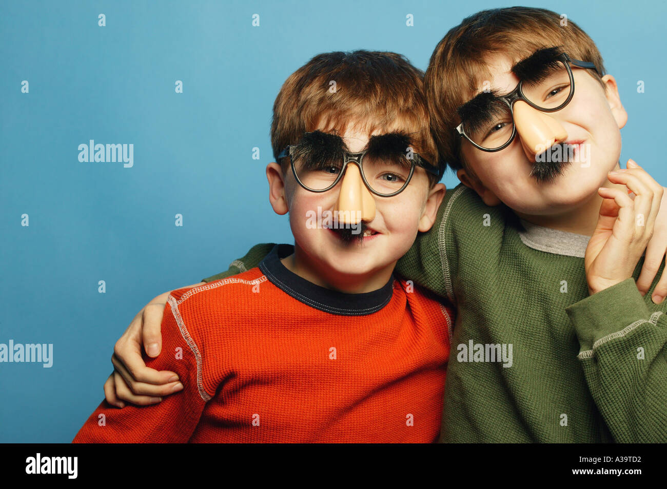 Two boys wearing funny masks Stock Photo - Alamy