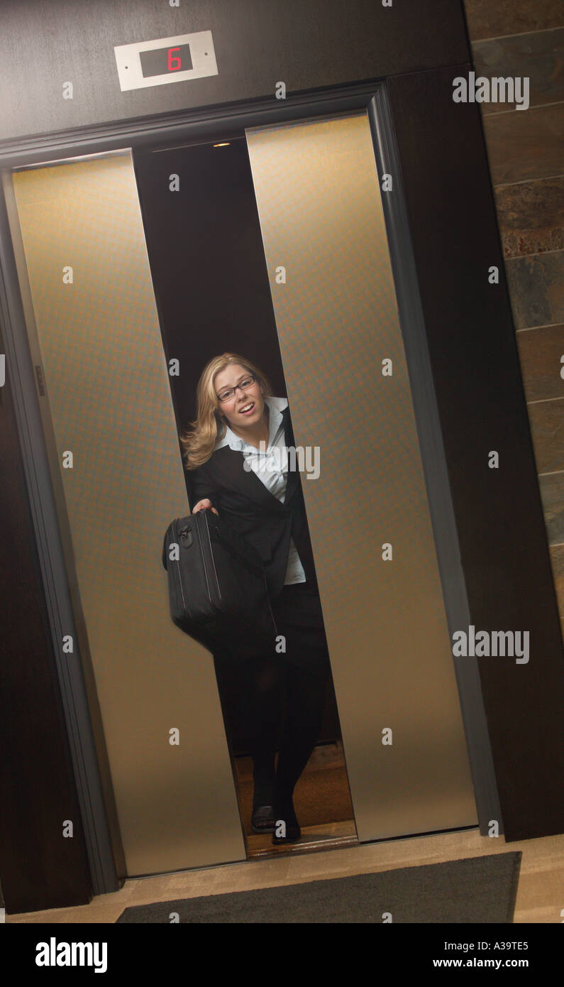 Late for work getting off elevator Stock Photo - Alamy