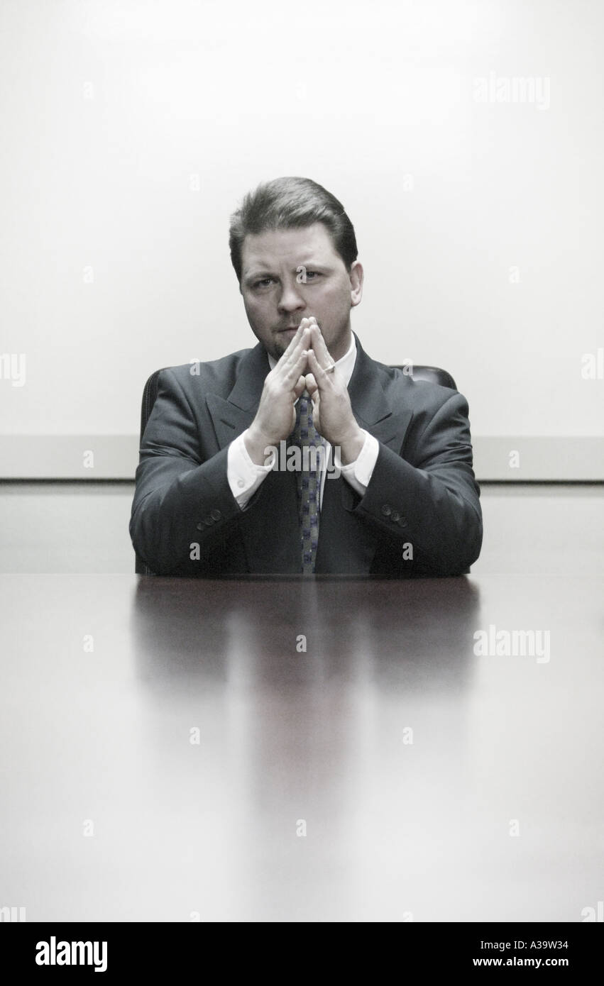 Executive sitting at boardroom table Stock Photo - Alamy