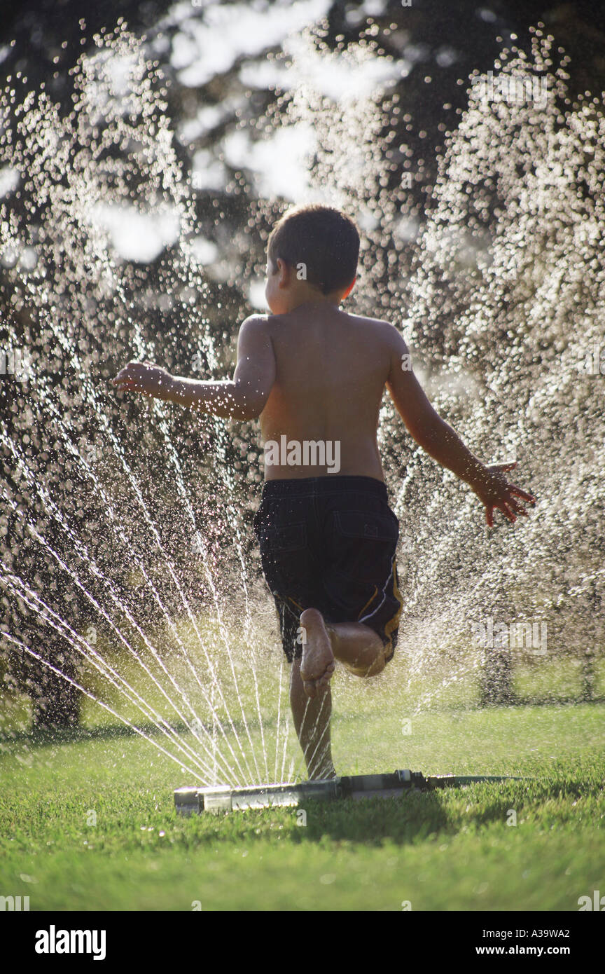 Run through water sprinkler hi-res stock photography and images - Alamy