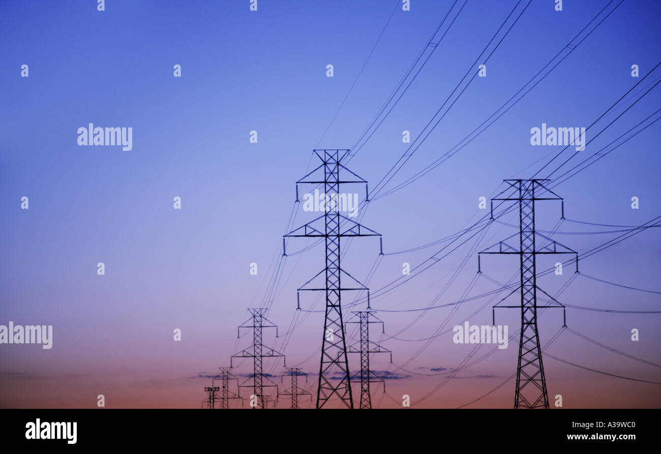 electricity pylons against a sunset backdrop Stock Photo - Alamy