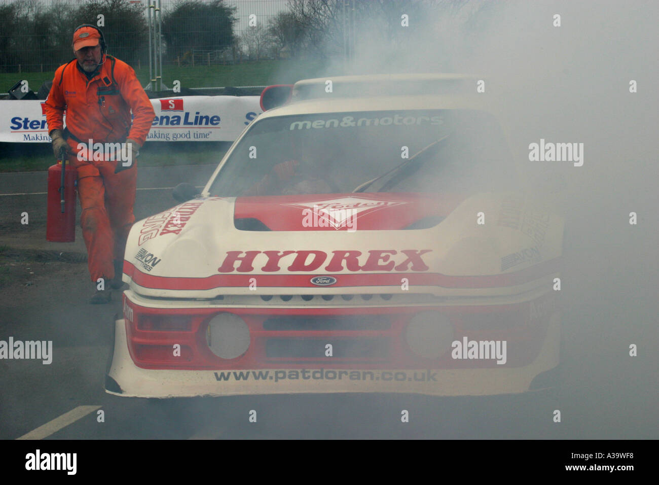 Rally cross car catches fire and fire marshall with extinguisher comes ...