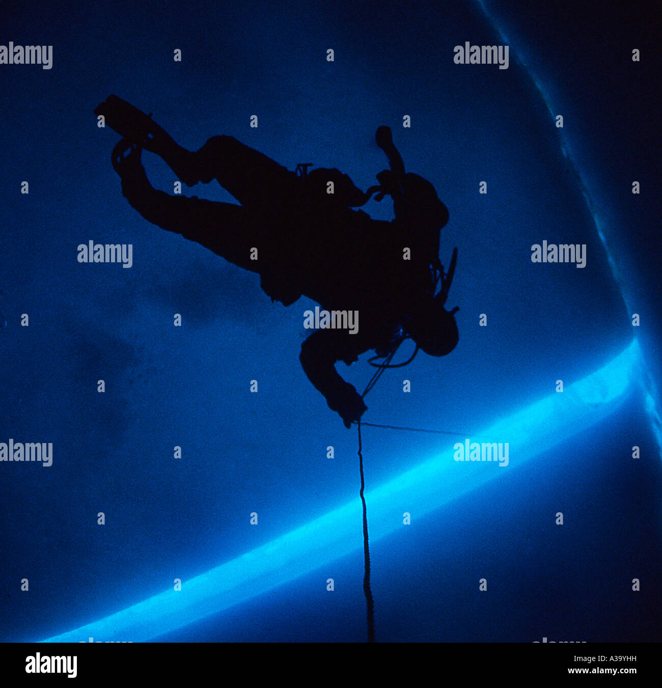 Ice diver in Arctic ice crack or lead in silhouette Stock Photo - Alamy