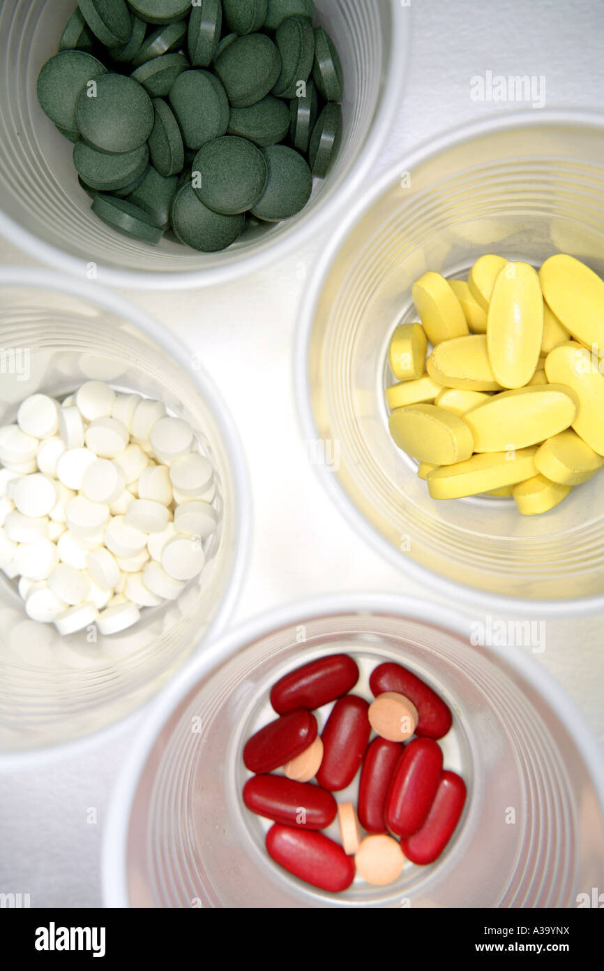 Pills and tablets inside plastic cups Stock Photo - Alamy