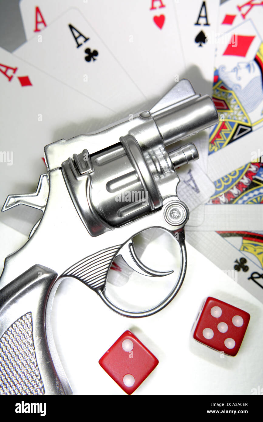 Handgun on top of playing cards Stock Photo - Alamy