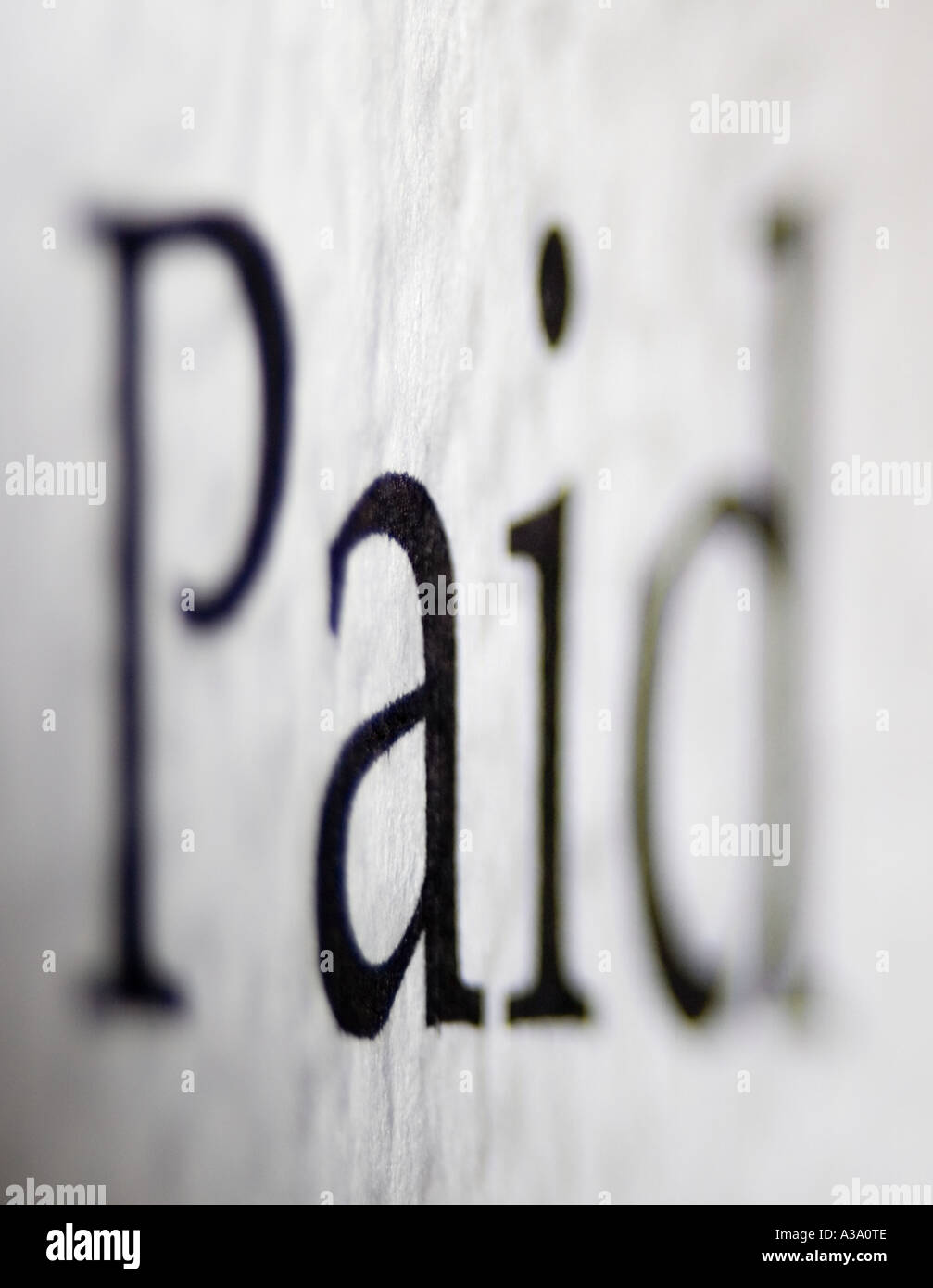 the word paid printed on to texture paper Stock Photo - Alamy