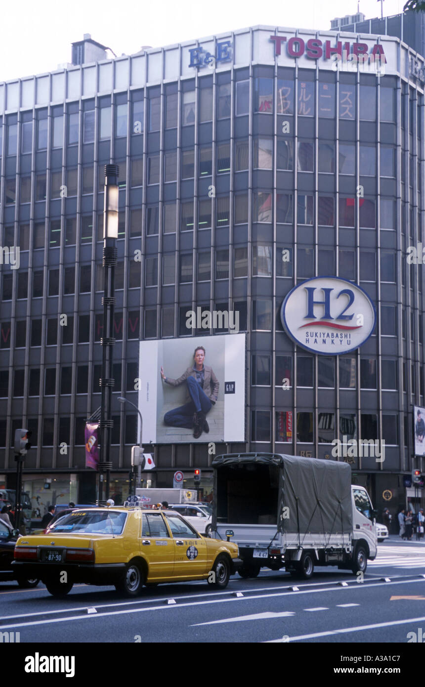 September 2001 Tokyo Japan Taxis drives past a GAP outlet in downtown ...