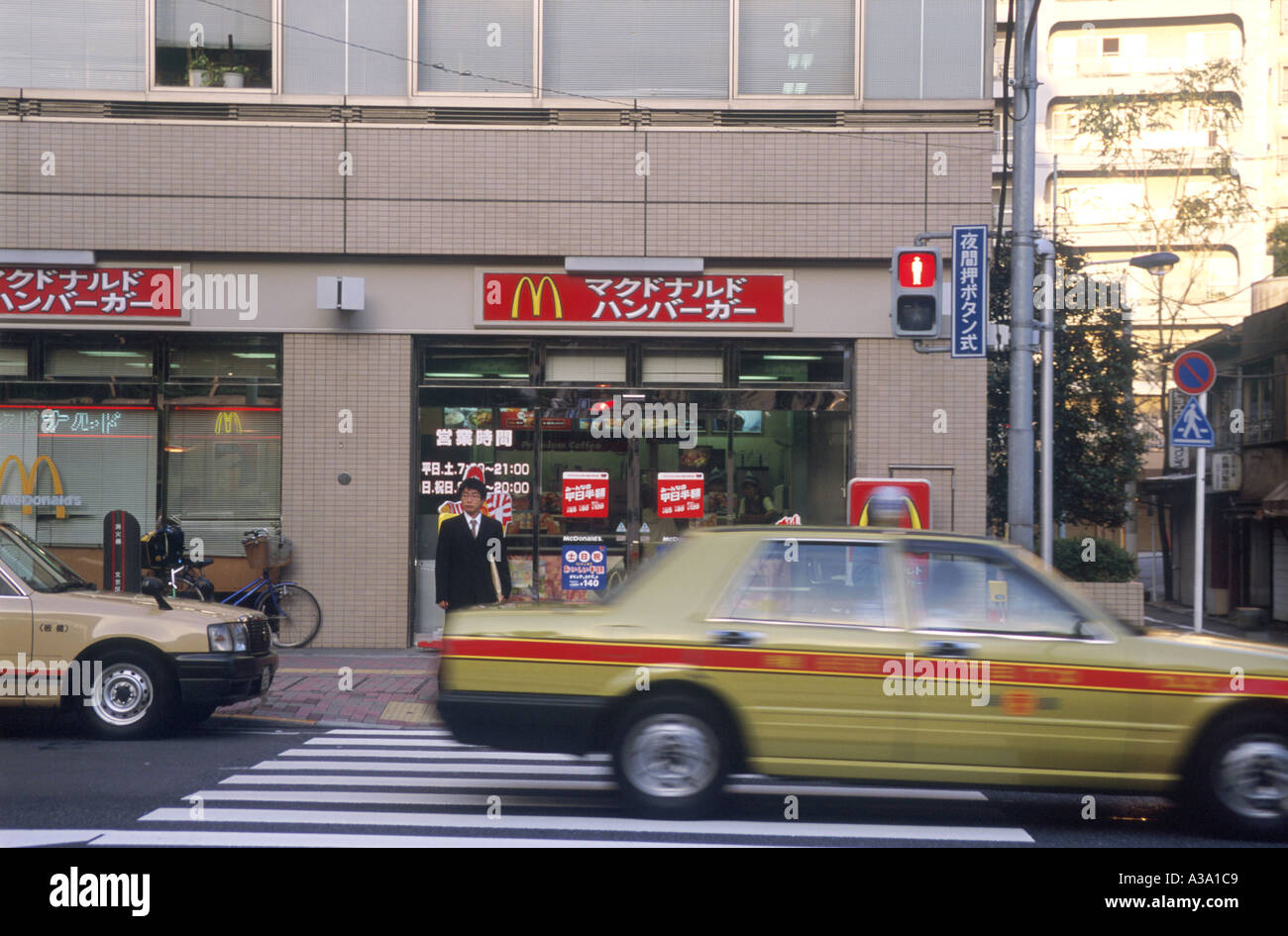 September 2001 Tokyo Japan Taxis drives past a McDonalds outlet in ...