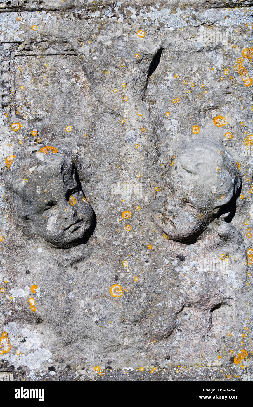 Cherubic face on a gravestone with orange lichen, Painswick Church ...