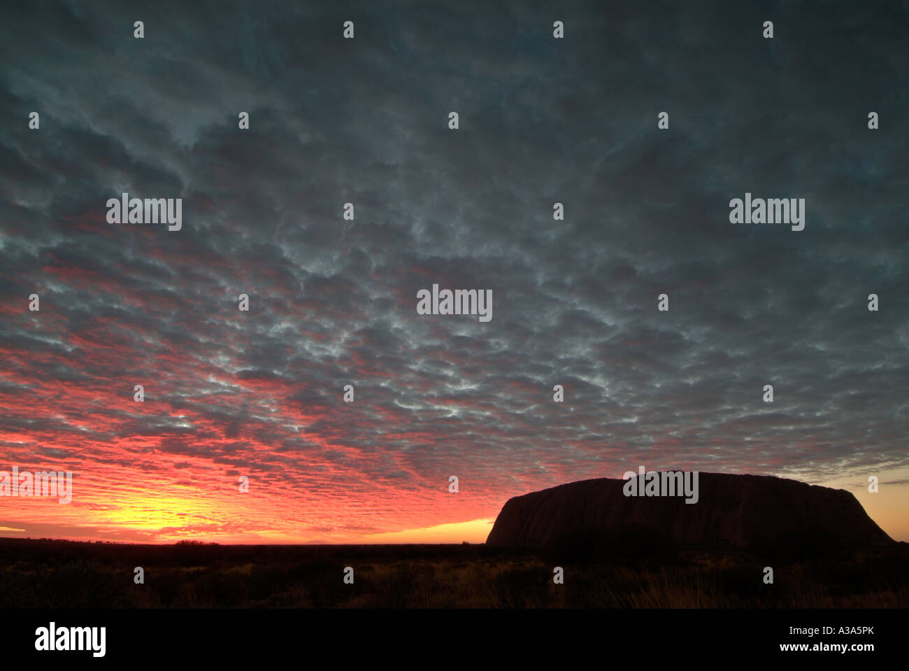 Dramatic and different view of Ayers rock at sunrise as seen from the ...