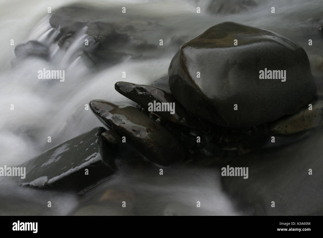 Boulders in a stream Stock Photo - Alamy
