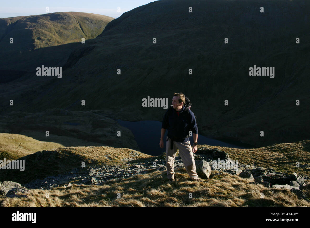 A male walker on the East Ridge of Mardale Ill Bell above Haweswater in ...
