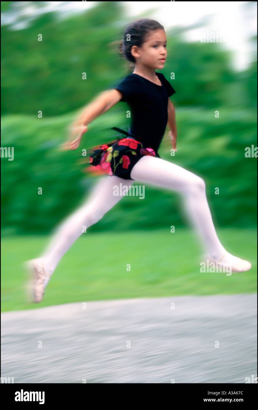 Young Girl Leaping in Dance Costume Stock Photo - Alamy