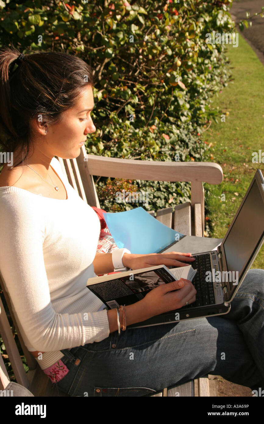 Attractive young female student sitting in the sun studying Stock Photo ...