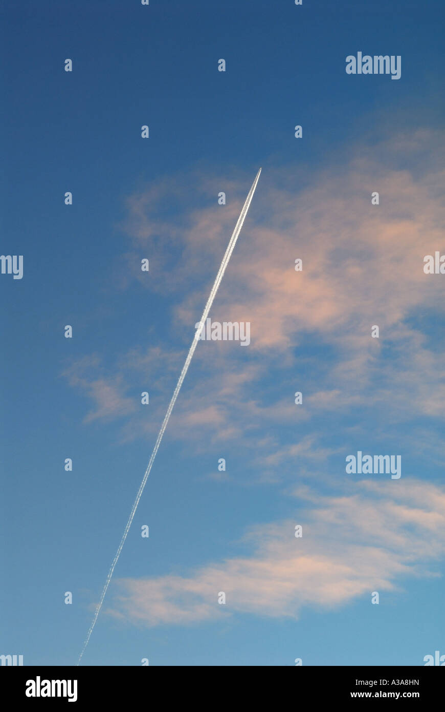 Contrail from a jet plane on the evening sky Stock Photo - Alamy