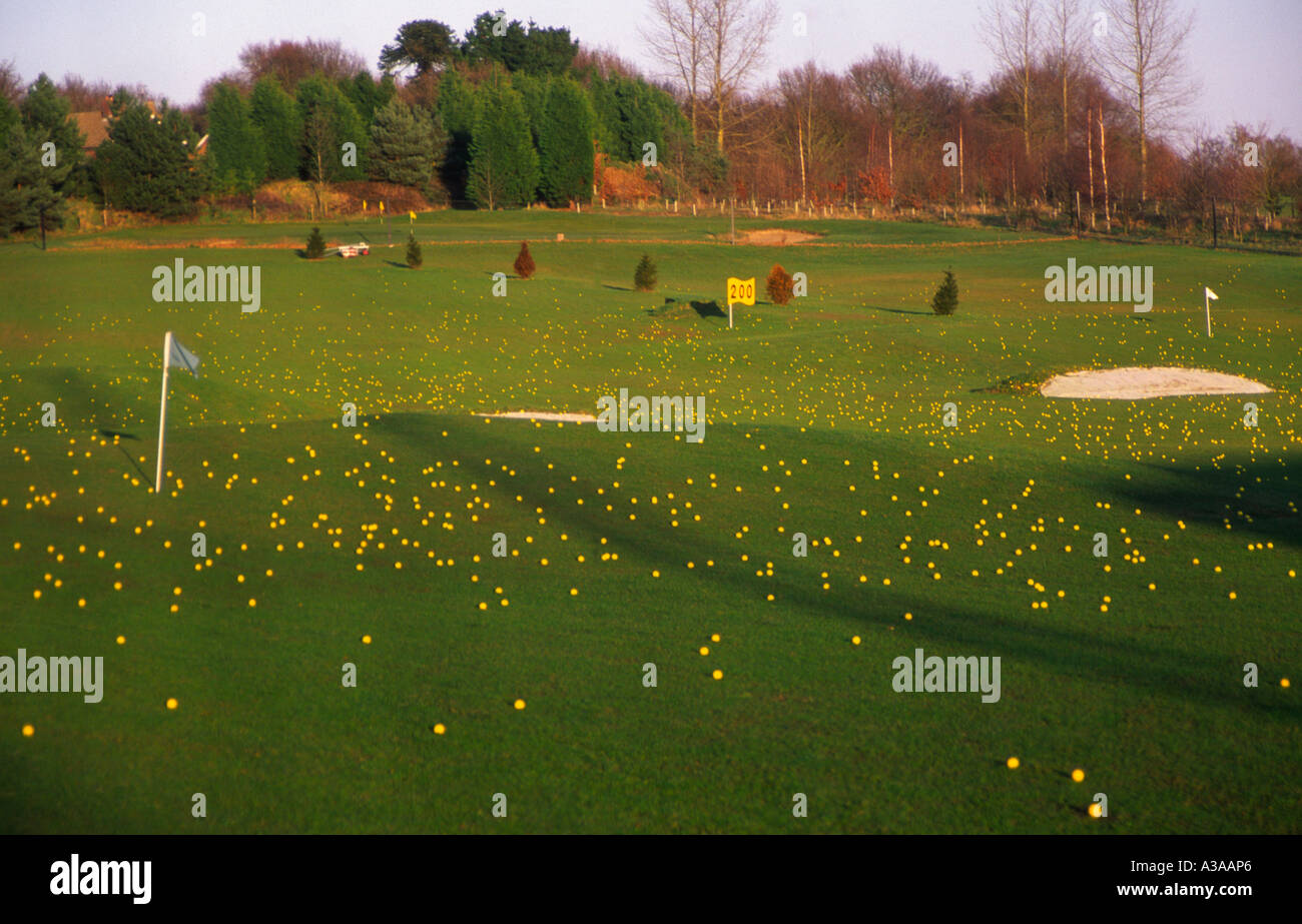Golf course driving range with yellow balls over the fairway and greens ...