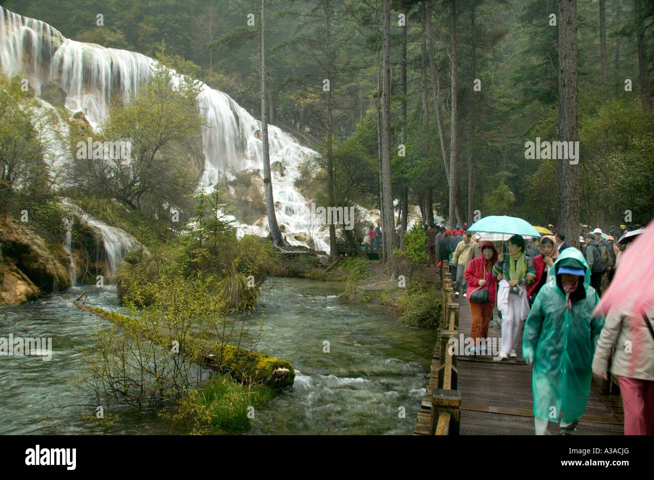 Tourists visiting Pearl Shoal Waterfall in the rain, Jiuzhaigou, UNESCO ...