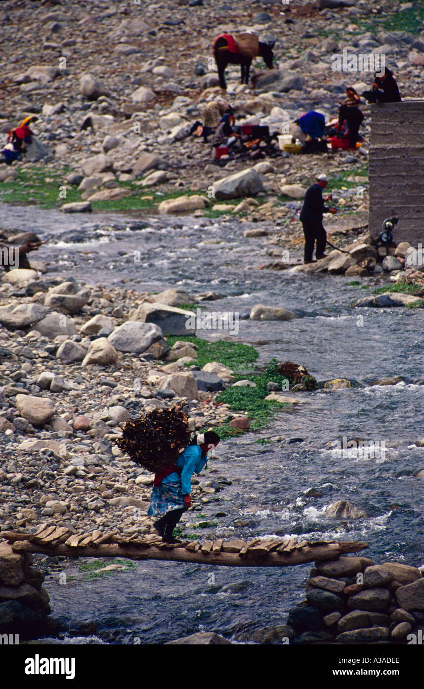 Woman carrying firewood over a narrow bridge Setti Fatma Morocco Stock ...