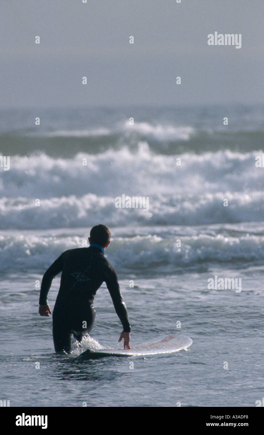 Surfer heading into the waves at Lahinch County Clare Ireland Stock ...