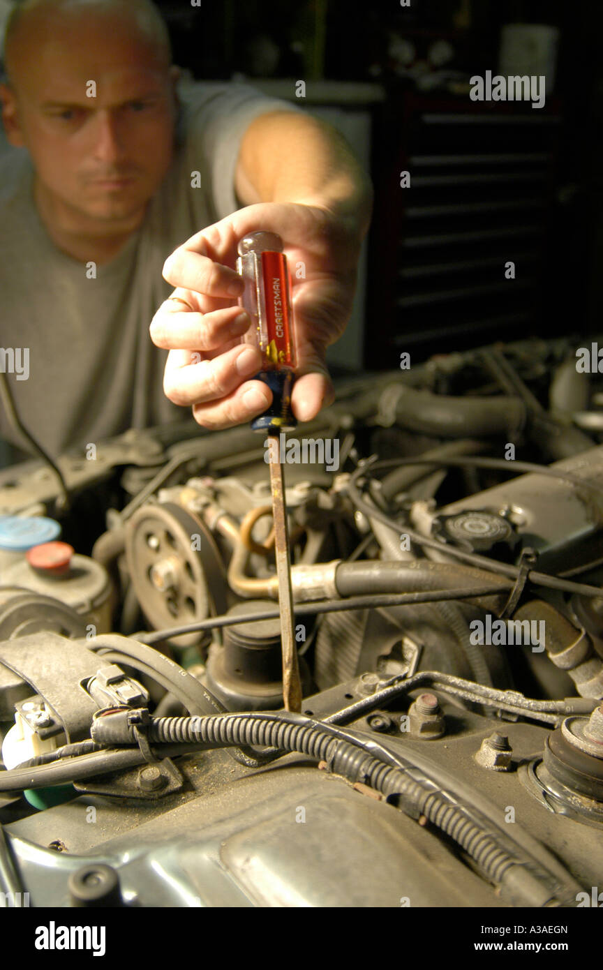 Mechanic Using Flat Head Screwdriver Stock Photo - Alamy