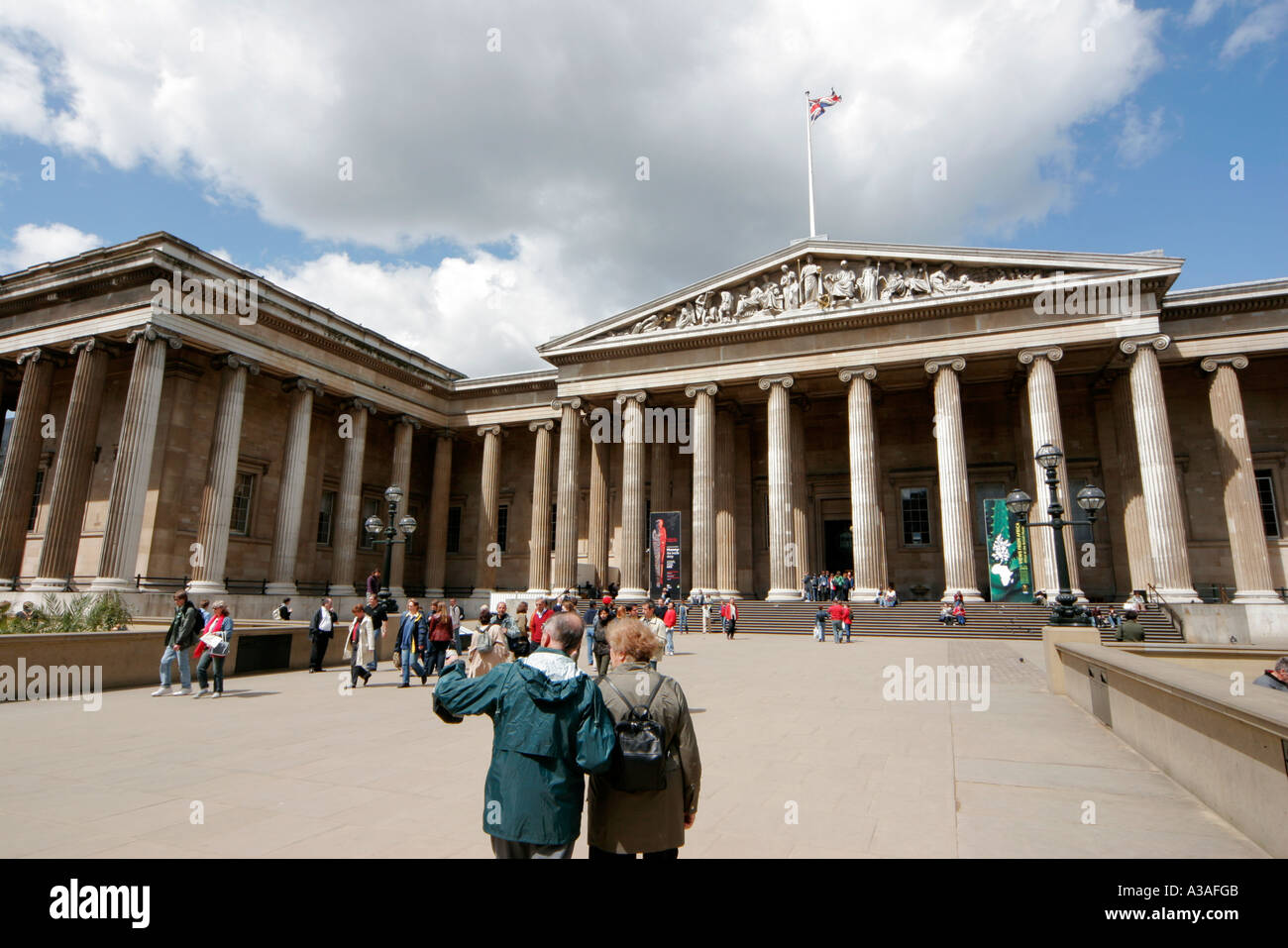 Visitors pause in front of the main entrance to the British Museum ...