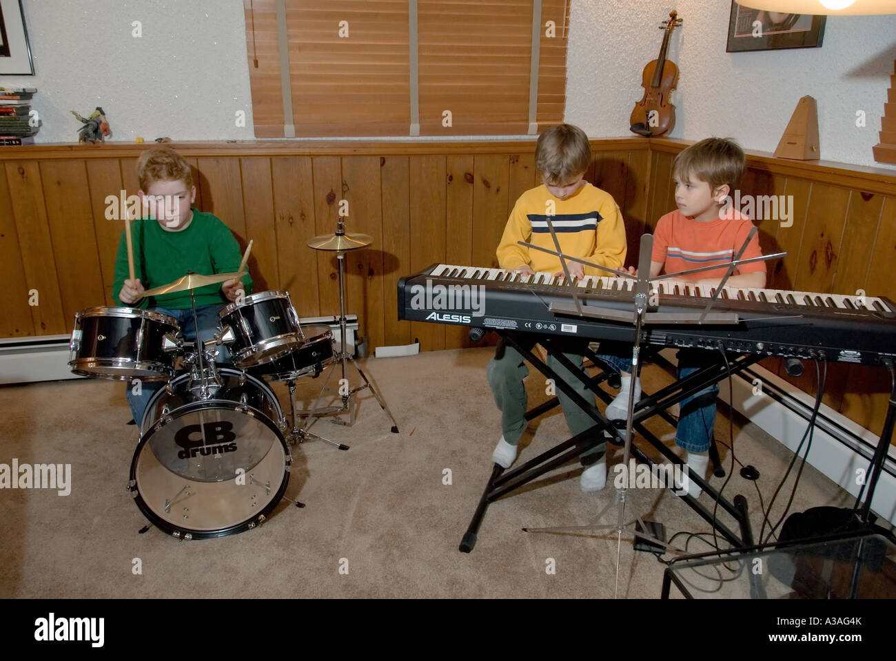 P33 038 Three 7-Year-Old caucasian boys playing Music - Drums Keyboard ...