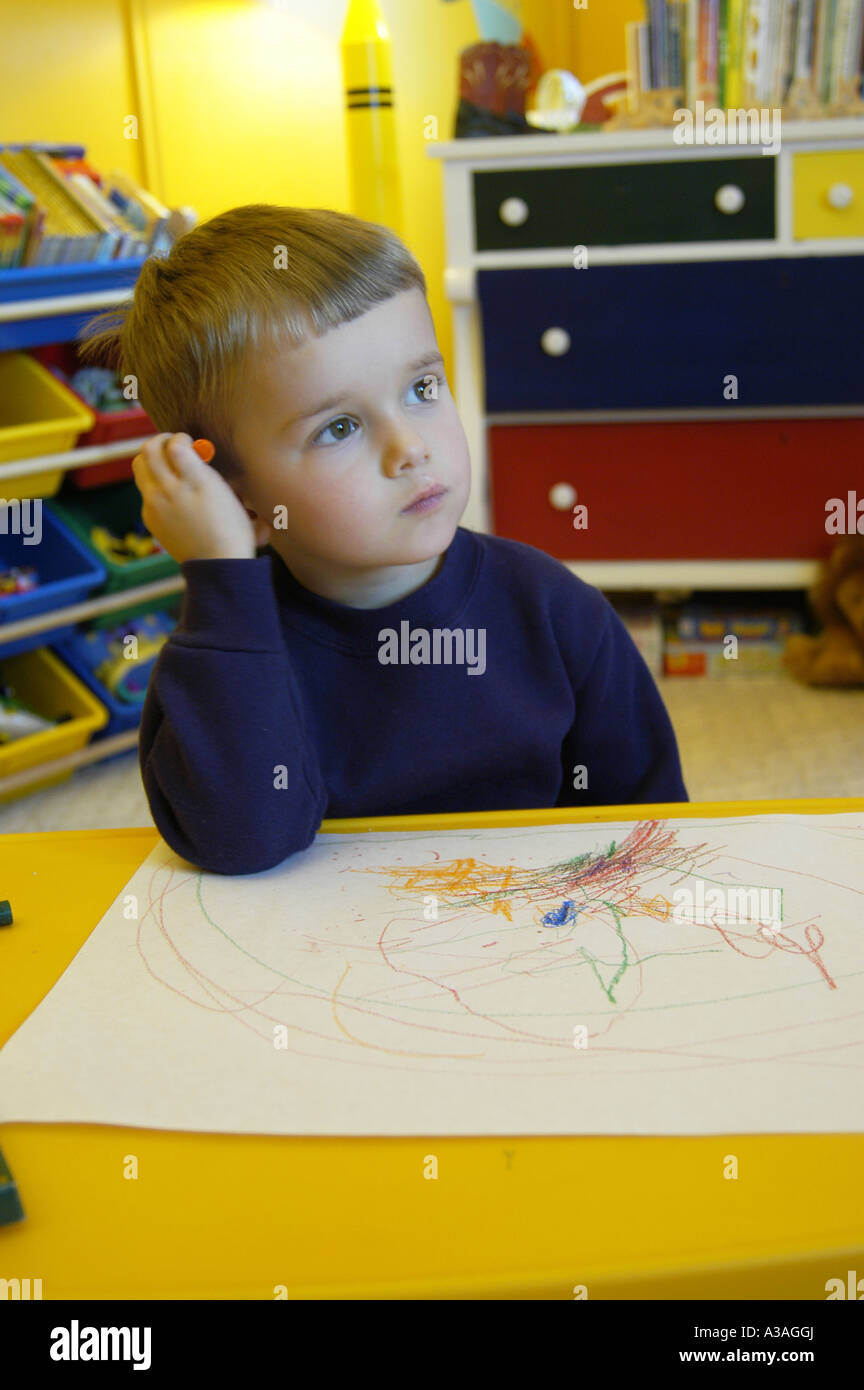 P4 115 3 year old drawing with crayons daydreaming Stock Photo - Alamy