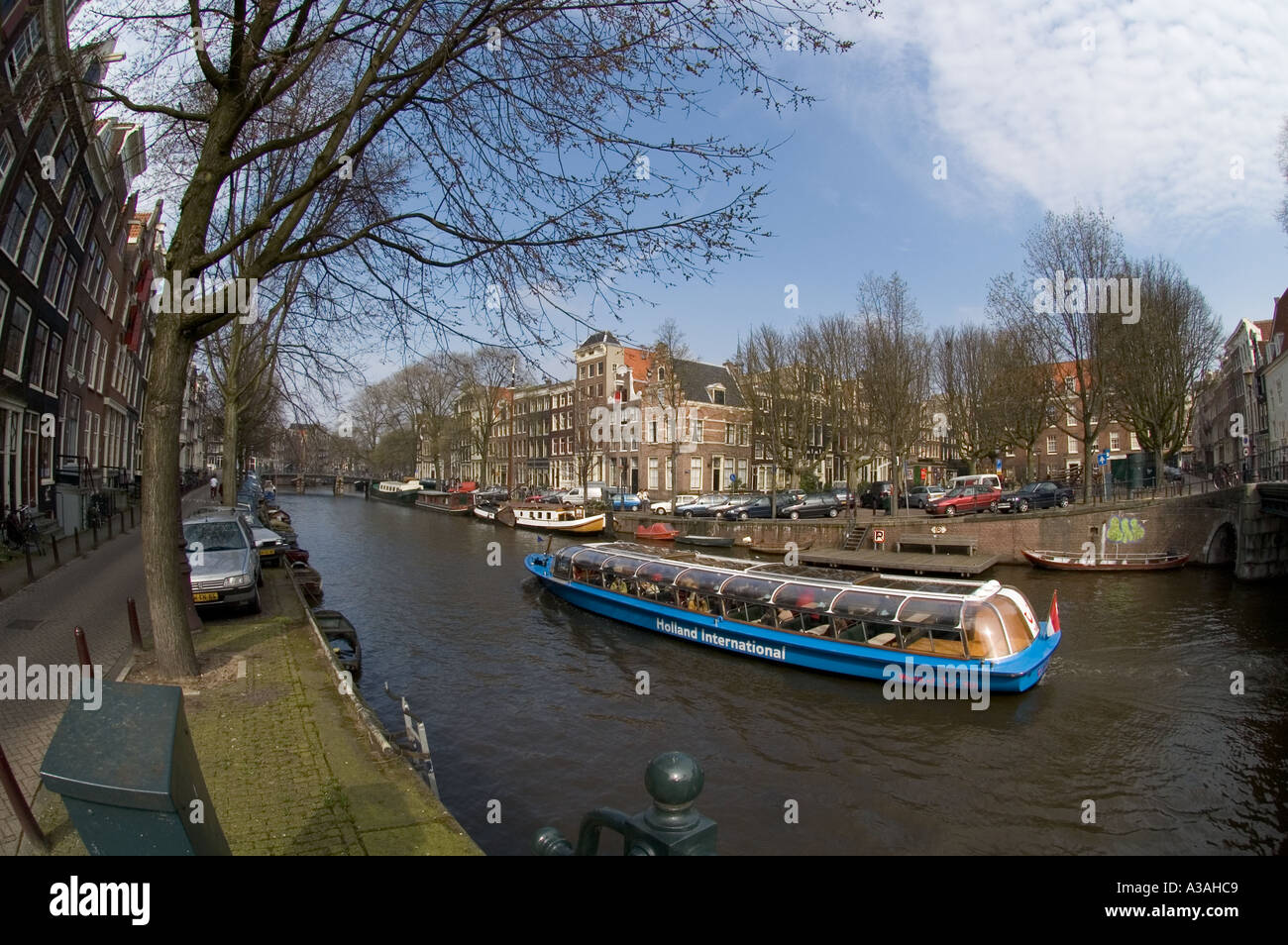 A water bus bring sightseers along one of the canals in Amsterdam Stock ...