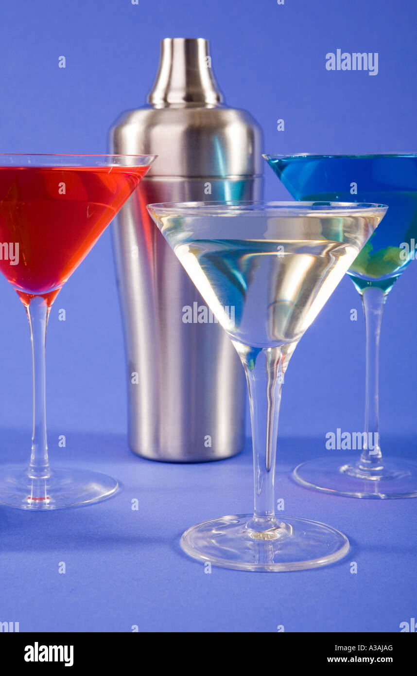 Three cocktails in red clear and blue with a cocktail shaker Stock ...