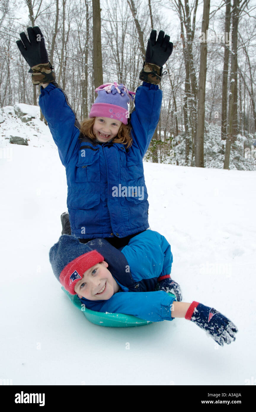 Sledding on a winter hill side Stock Photo - Alamy
