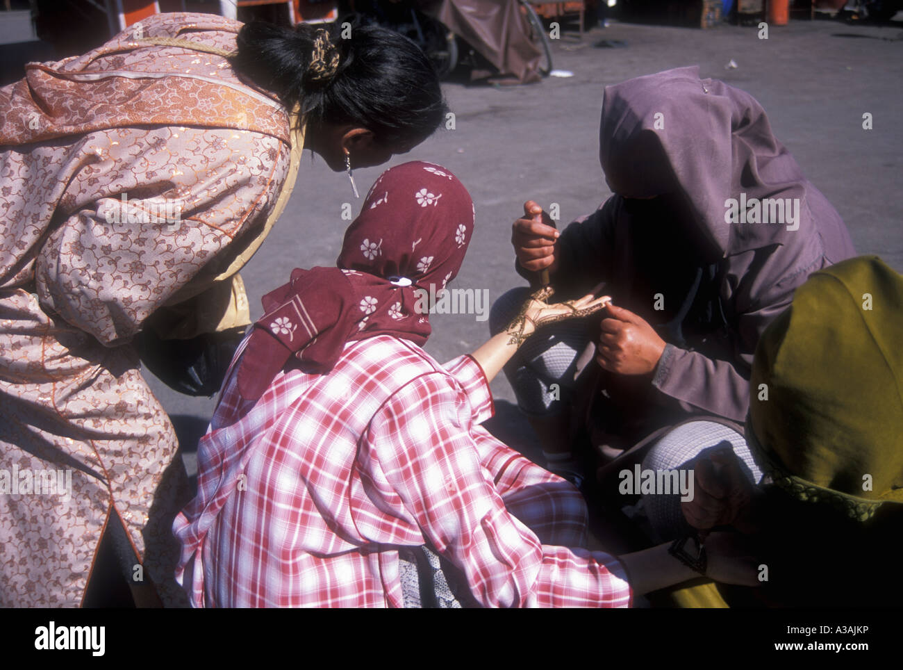 Muslim lady s hands being painted with Harqus non permanent tattoos In ...