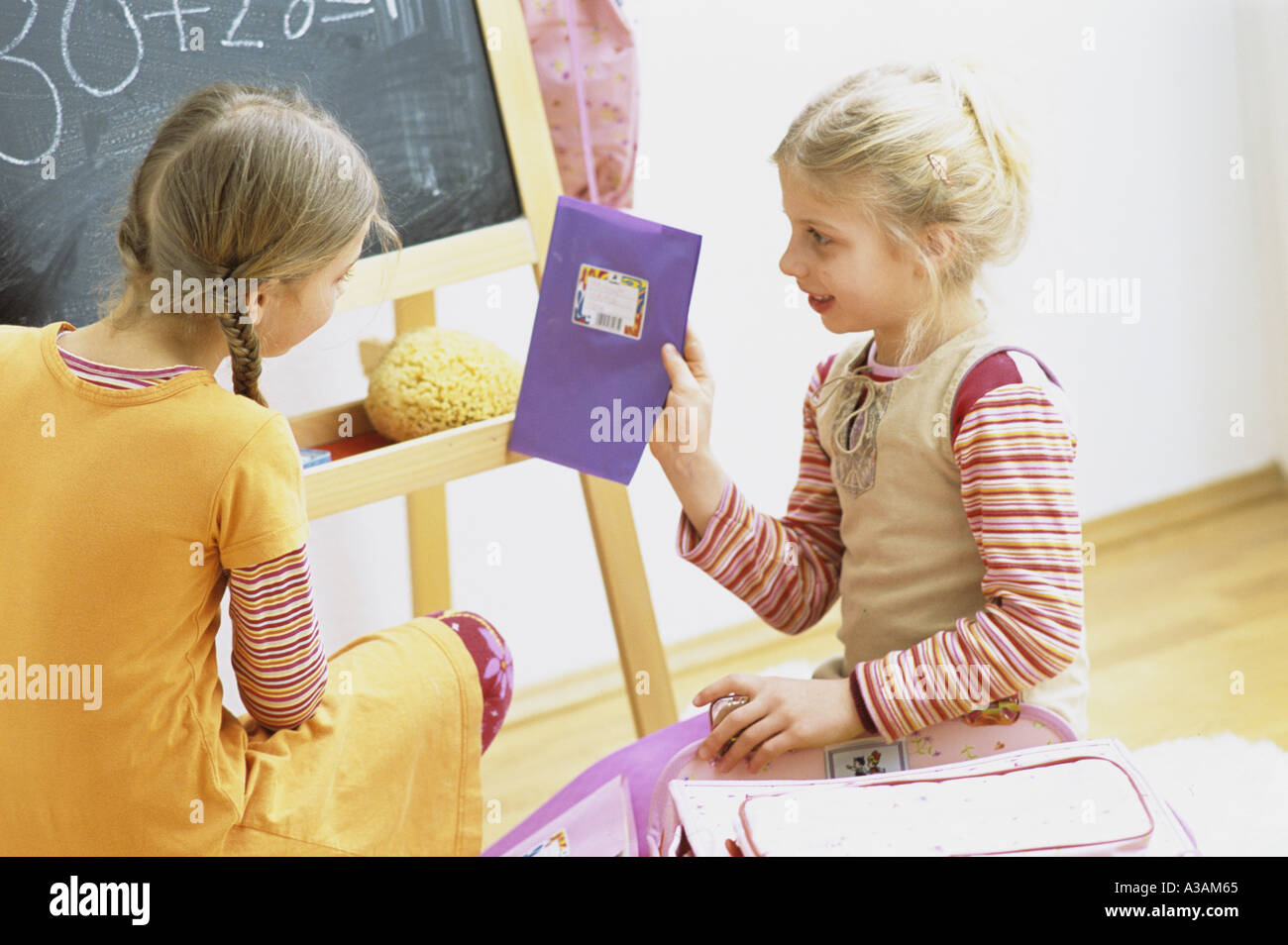 Two school girls hold hi-res stock photography and images - Alamy