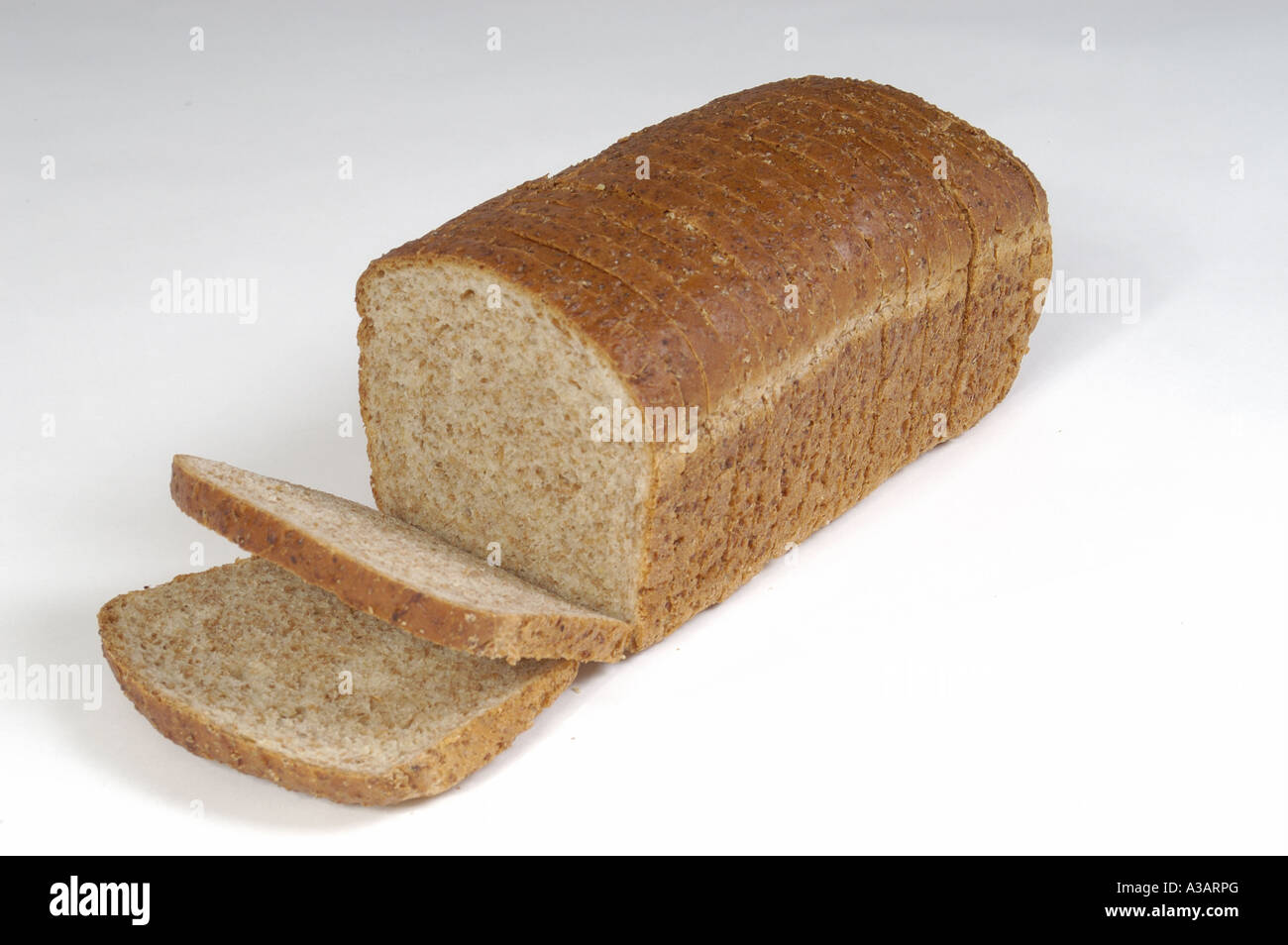 Studio shot of sliced, wholegrain loaf of bread on white background ...