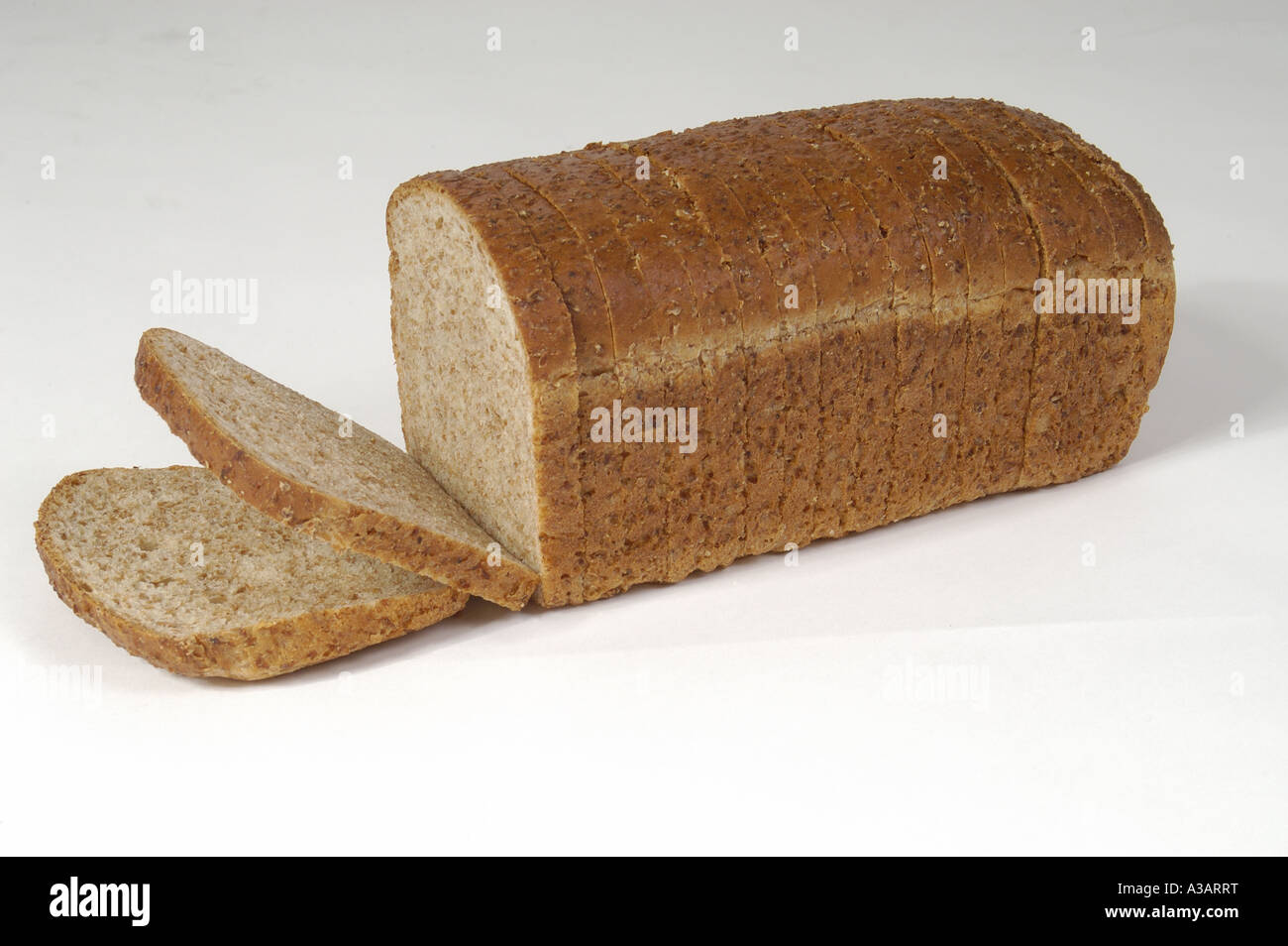 Studio shot of sliced, wholegrain loaf of bread on white background ...