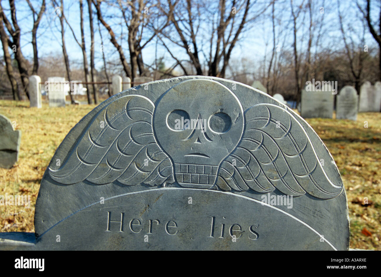 Old weathered New England headstones--Face and wings Stock Photo - Alamy