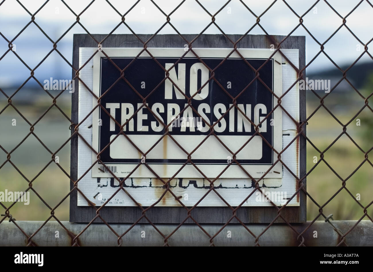 Chain link fence with No Trespassing sign Stock Photo - Alamy