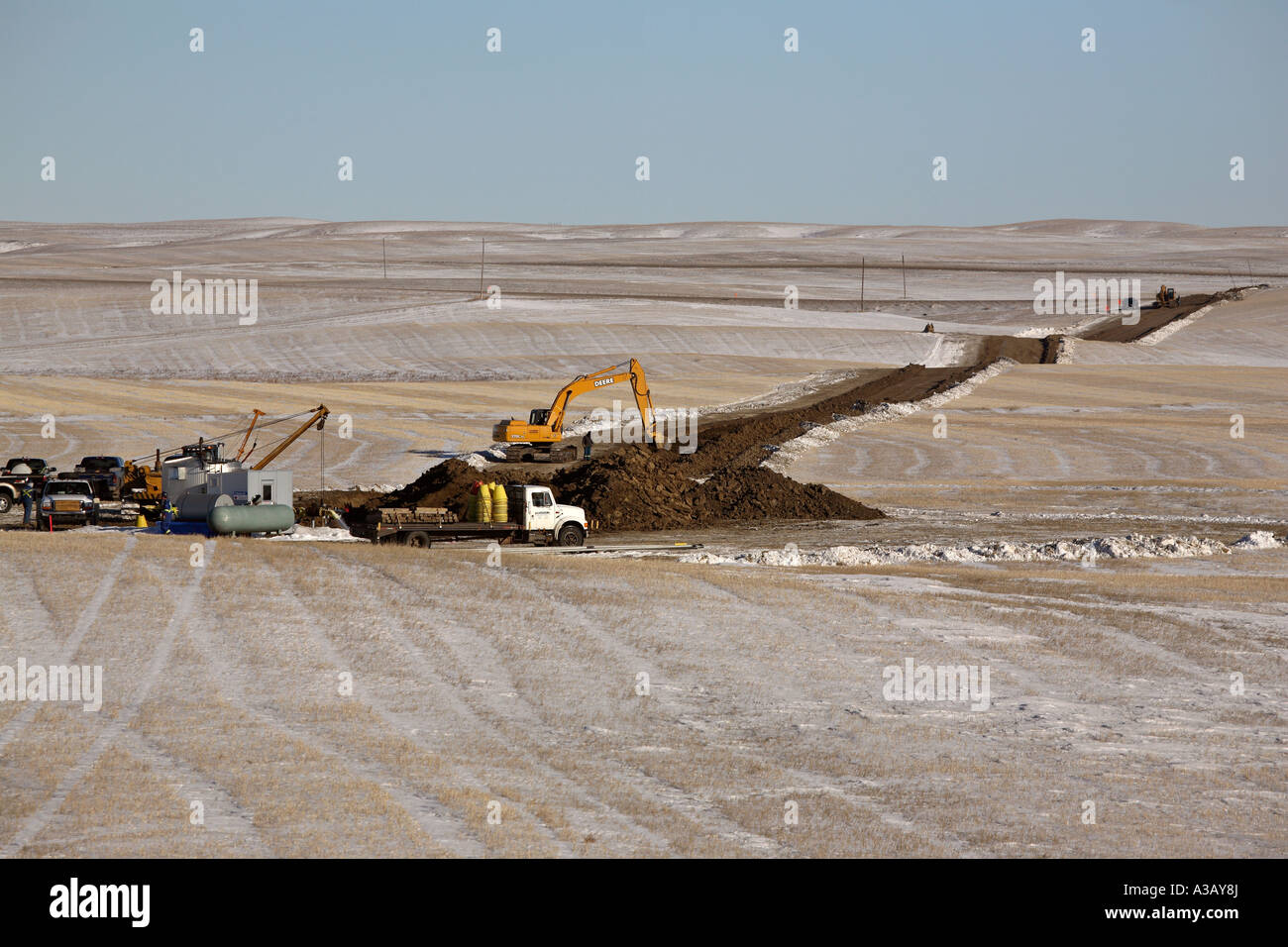 Track hoe digging pipeline ditch Stock Photo - Alamy