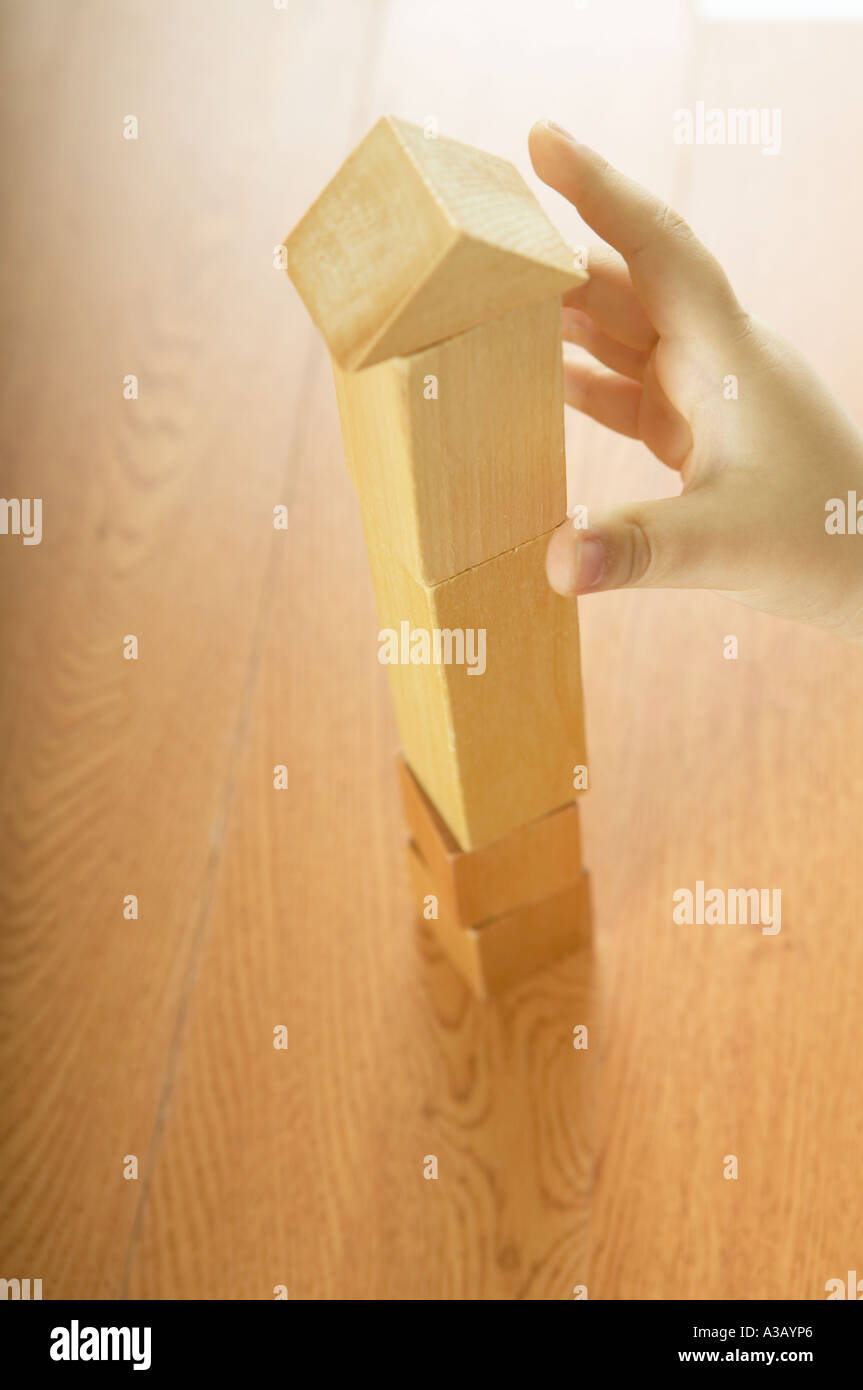 A child stacking wooden toy blocks Stock Photo - Alamy