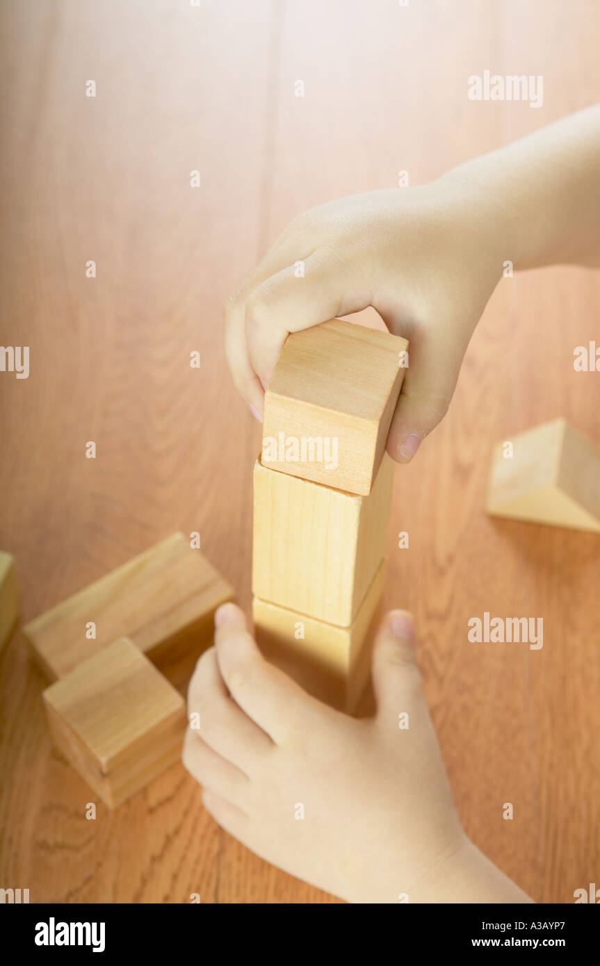 A child stacking wooden toy blocks Stock Photo - Alamy