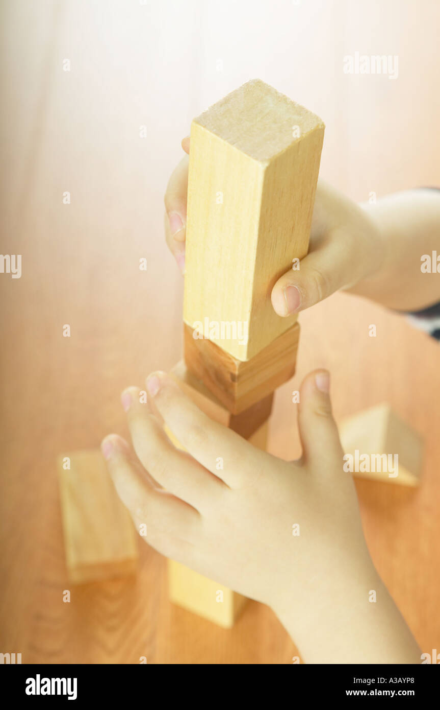 A child stacking wooden toy blocks Stock Photo - Alamy