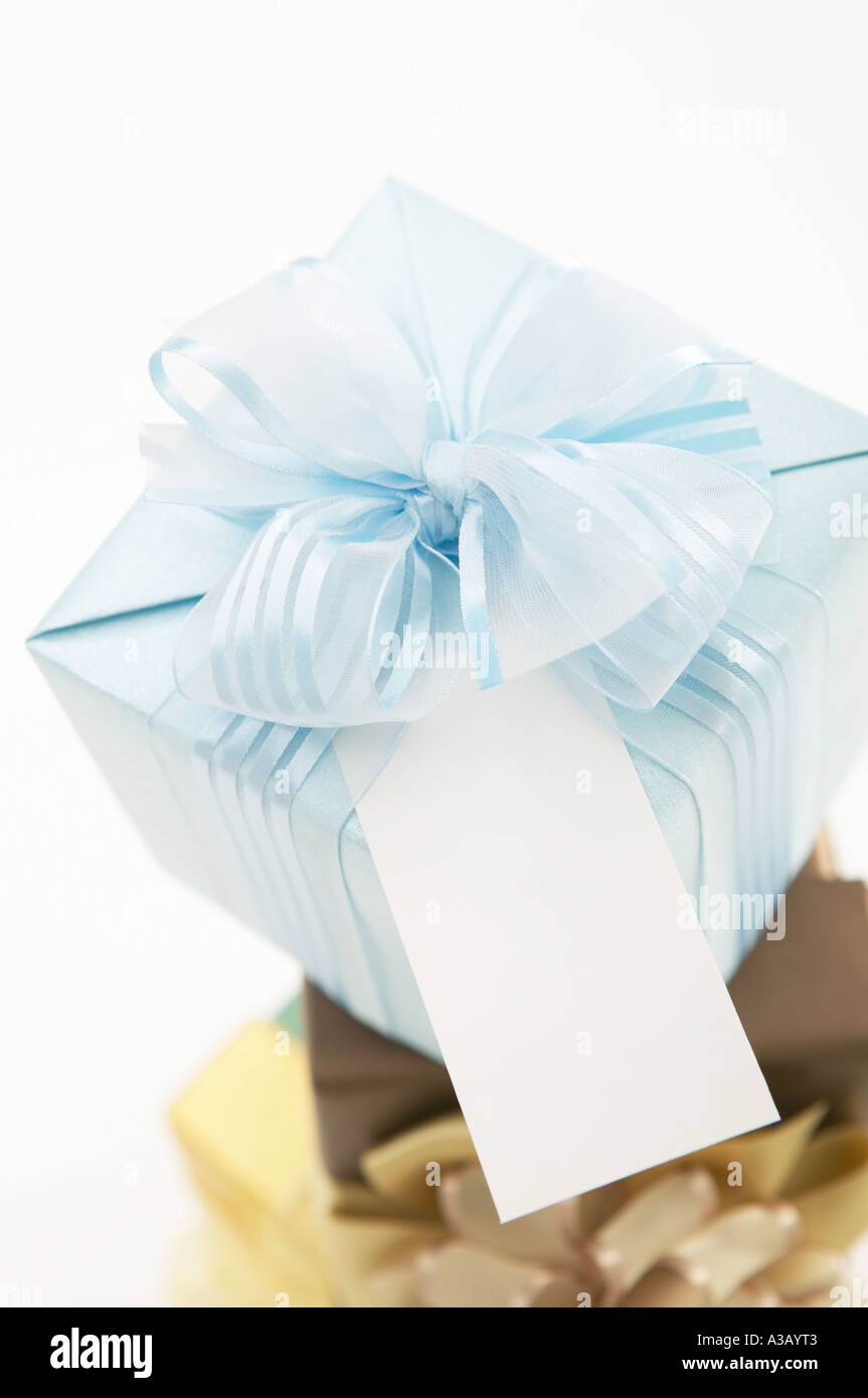 A pile of gift boxes in white background with an empty greetings note ...