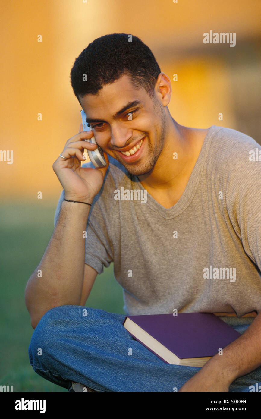 Male student talking on a cellphone Stock Photo - Alamy