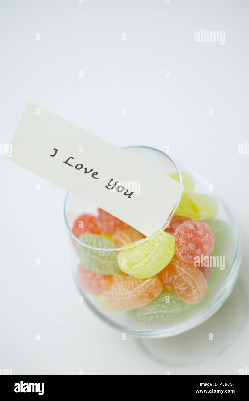 Candies and a greetings note in the glass in white background Stock ...