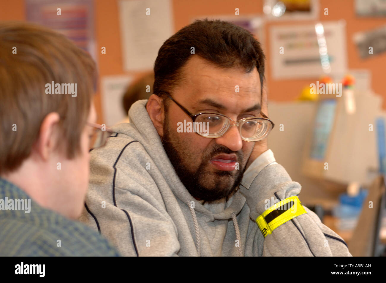A man with learning disabilities talks to his friend at a community ...