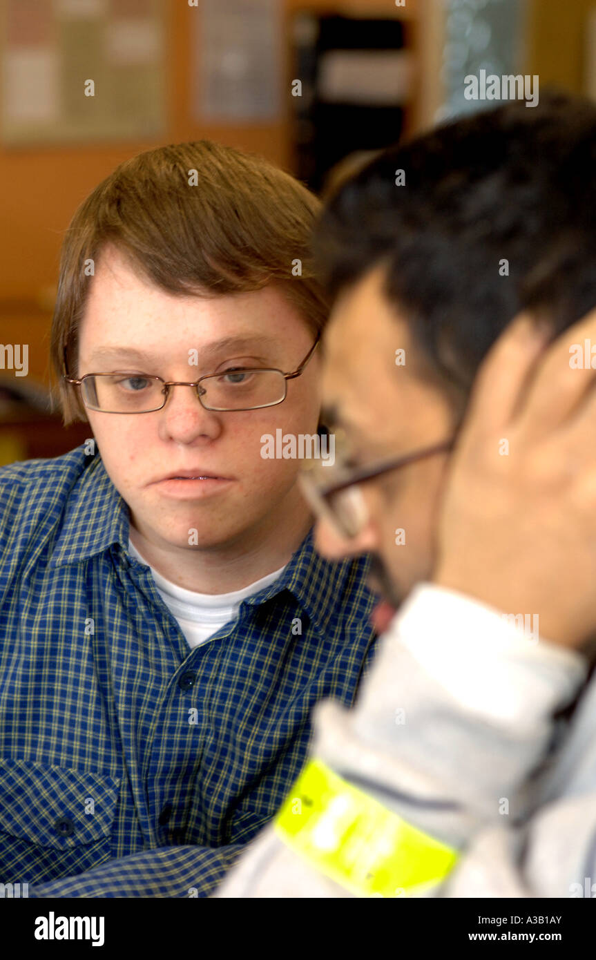 A man with learning disabilities talks to his friend at a community ...